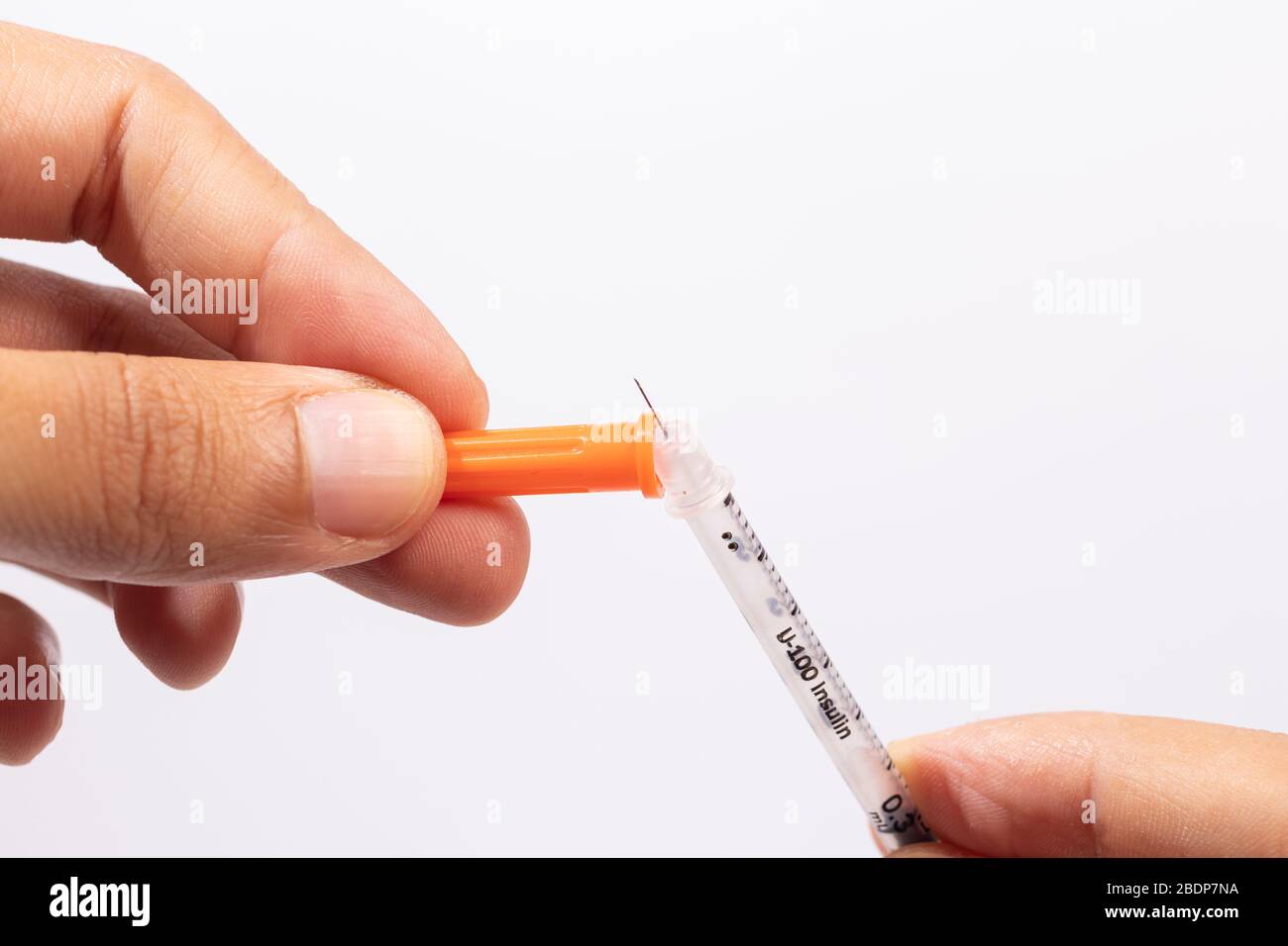 Hand holding an insulin syringe before being used Stock Photo - Alamy