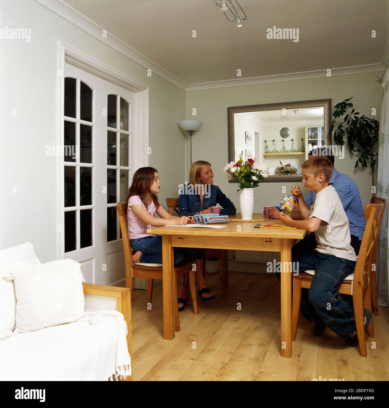 Family Talking At Dinner Table