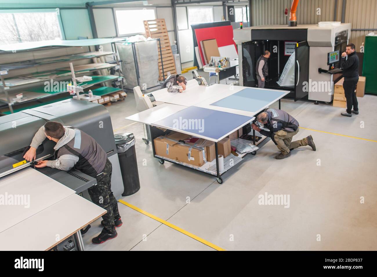 Large group of worker printmaker technician operator works in digital ...