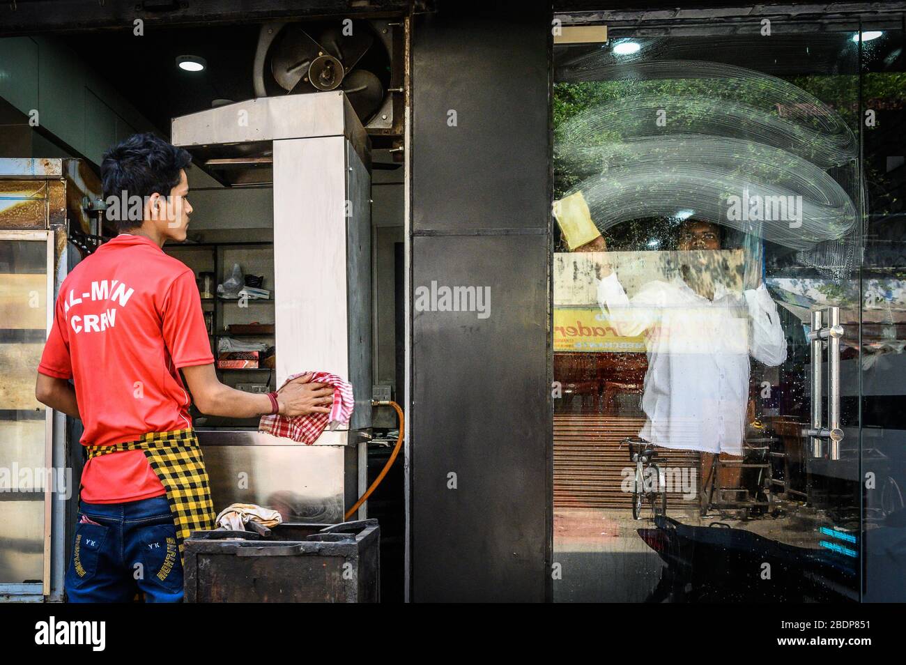 Two men cleaning up in adjacent shops, Chennai, India Stock Photo - Alamy
