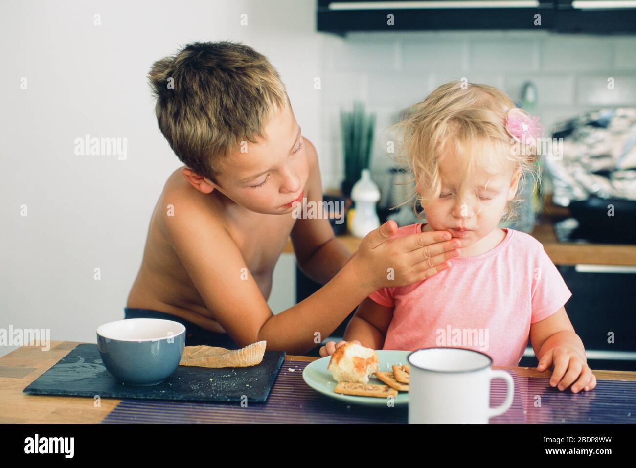 Little girl is taken care of. Brother always looking after her Stock ...
