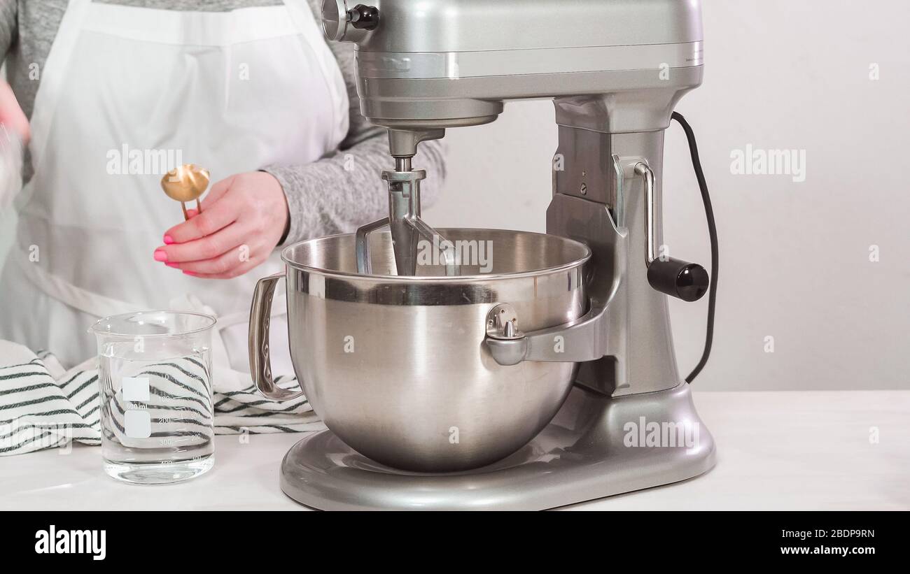 Step by step. Flat lay. Mixing royal icing in electric kitchen mixer ...