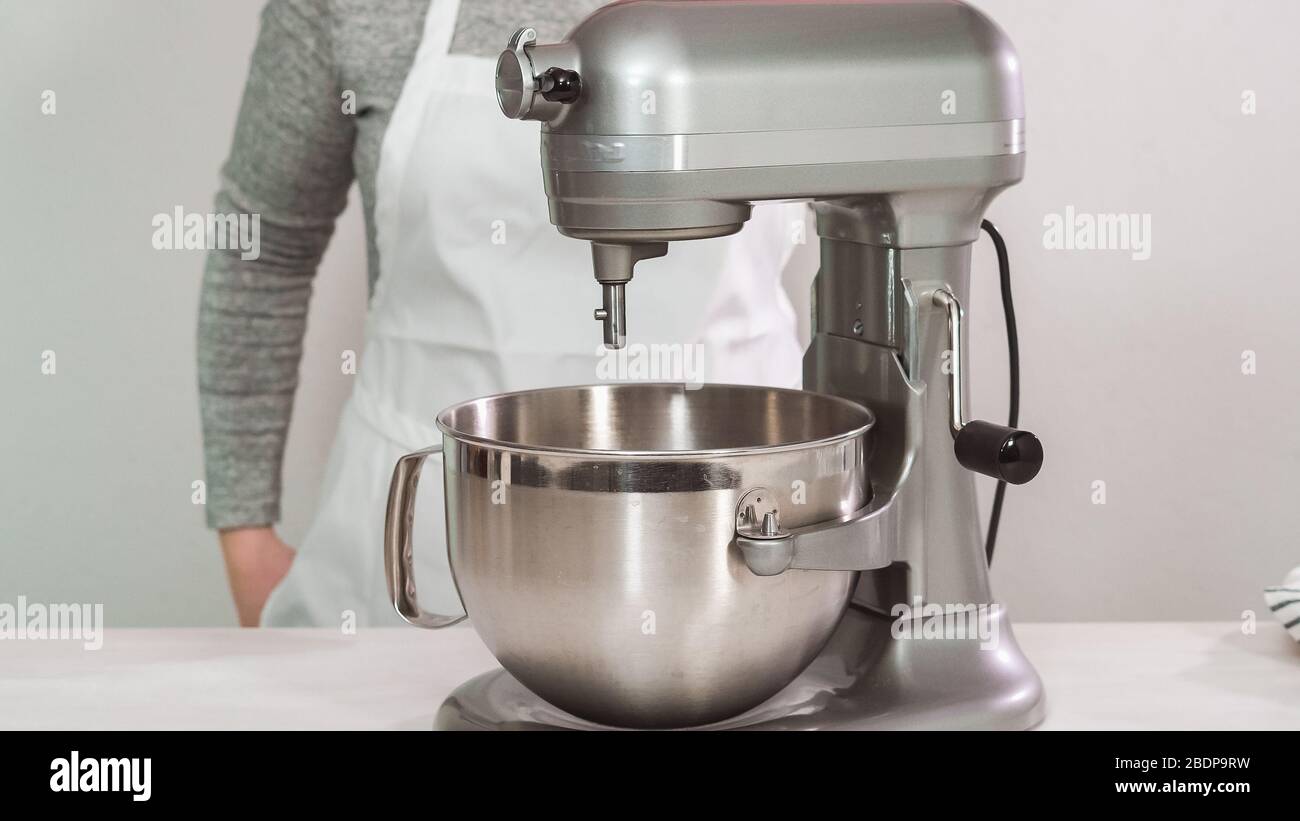Step by step. Flat lay. Mixing royal icing in electric kitchen mixer ...