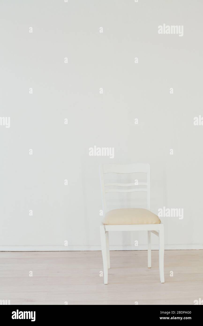 one chair in the interior of an empty white room Stock Photo - Alamy
