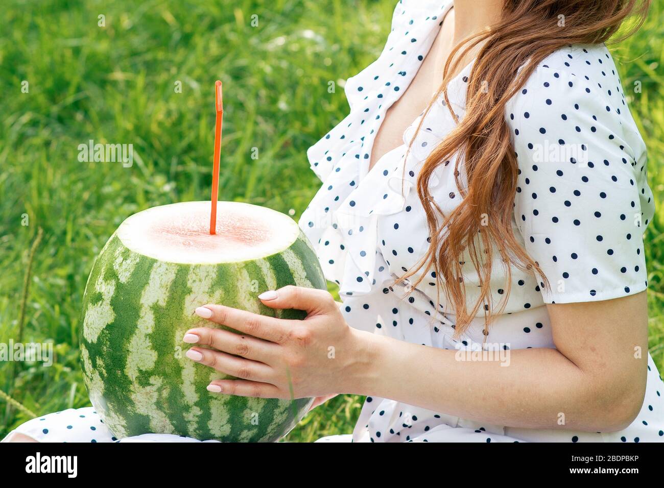 Beautiful young woman with watermelon sits on grass outdoors Stock ...