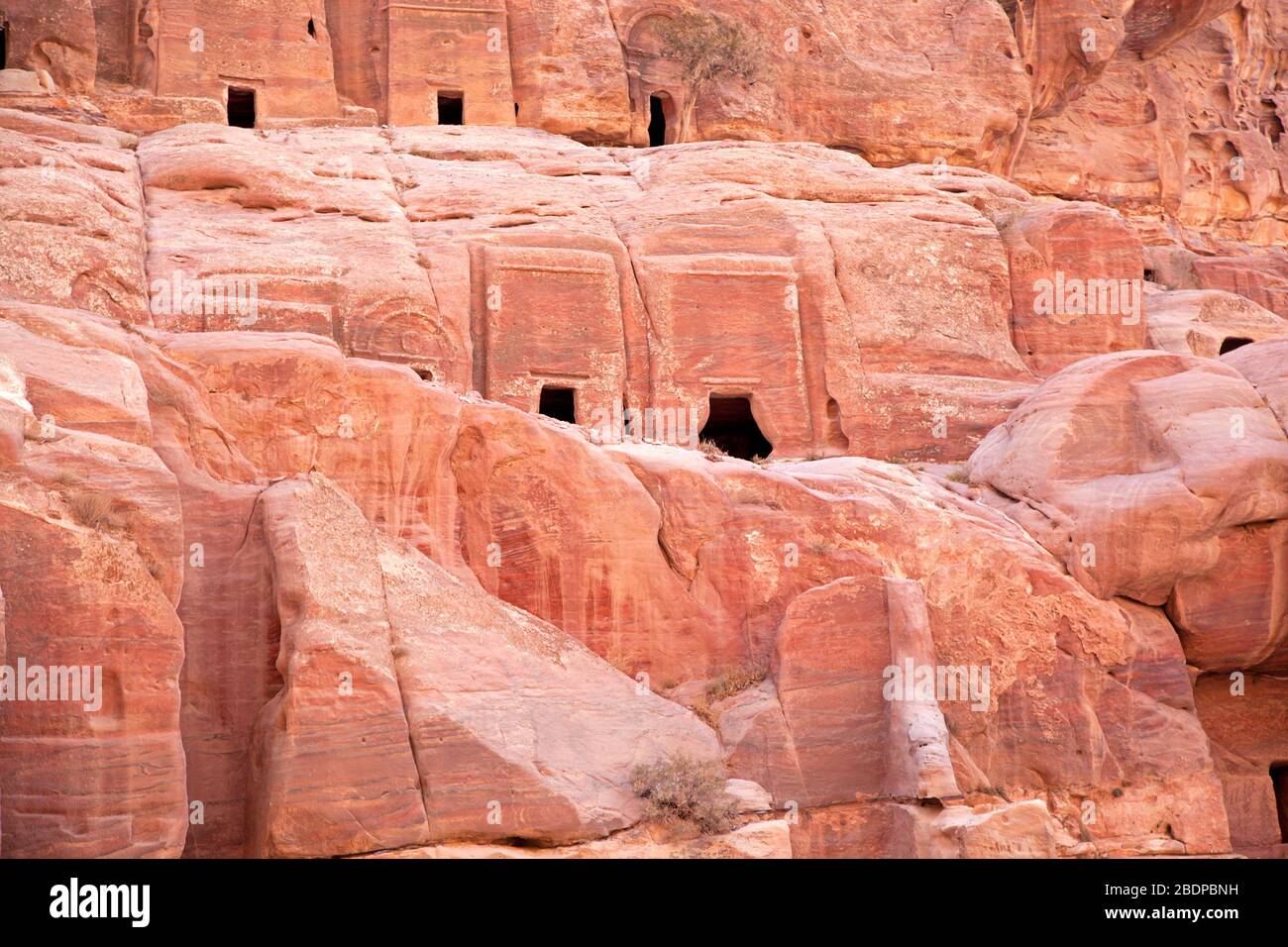 Ancient buildings carved into the stone in the Rose City of Petra ...