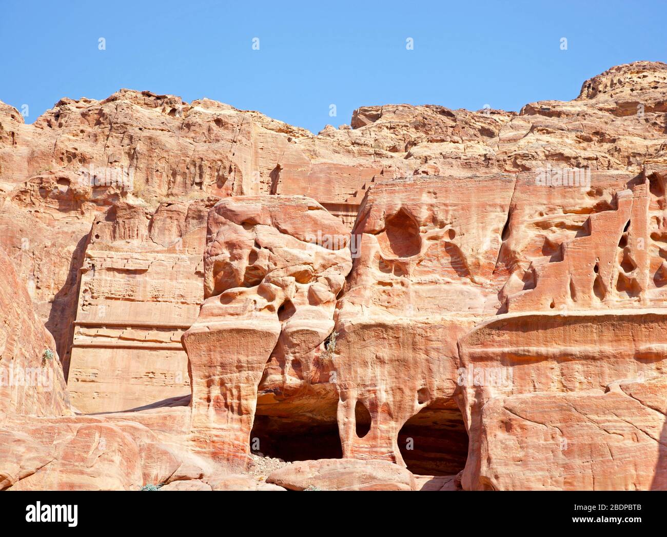 Ancient buildings carved into the stone in the Rose City of Petra ...