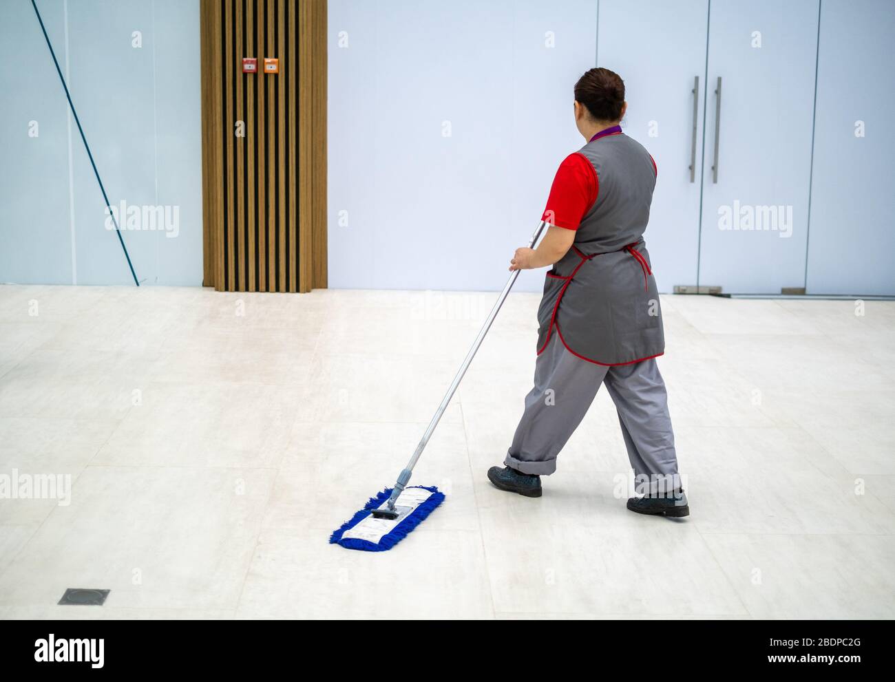 Сleaning company employee washes floor Stock Photo - Alamy