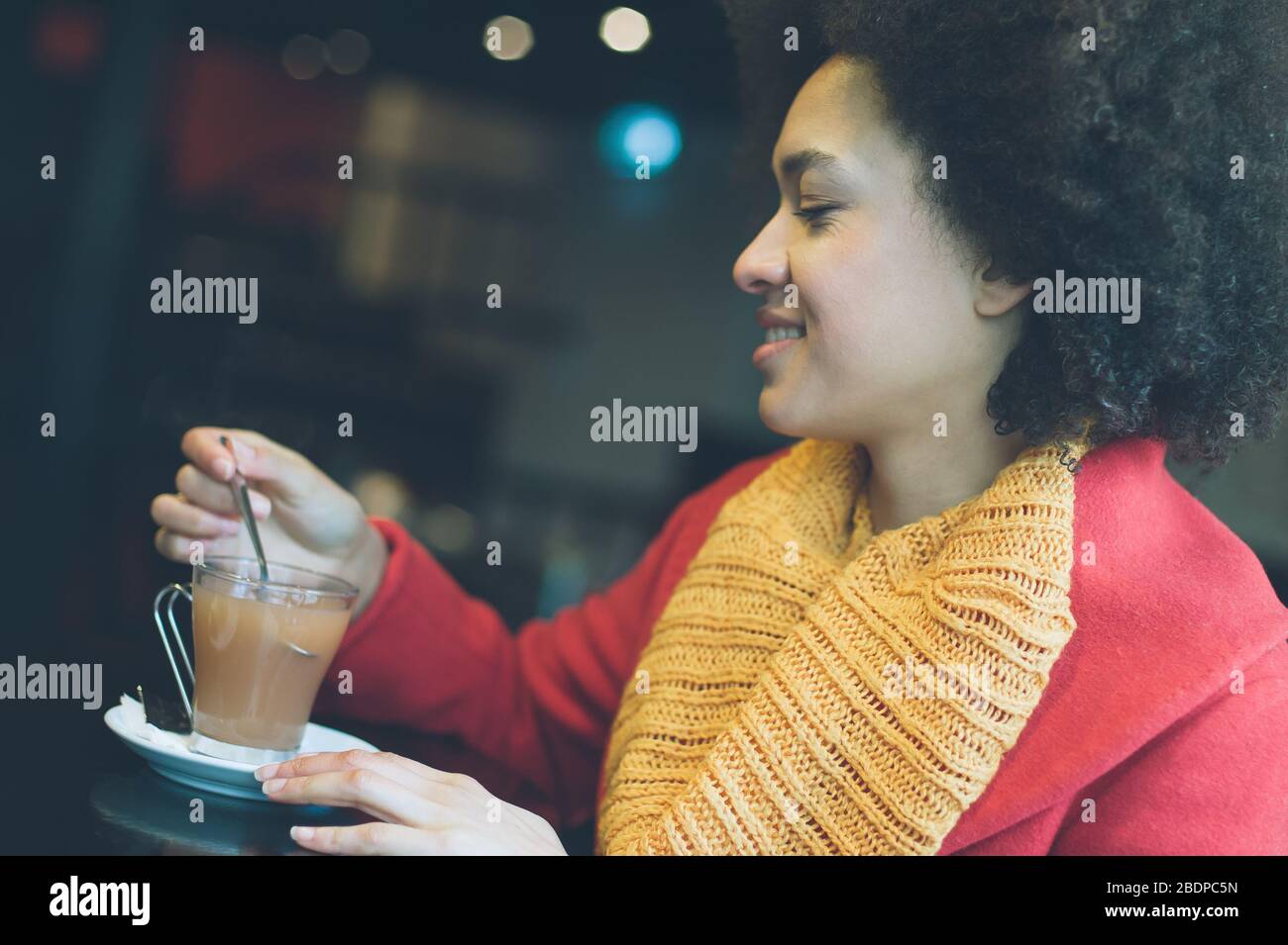 Portrait of beautiful young woman enjoying tea in a restaurant Stock ...