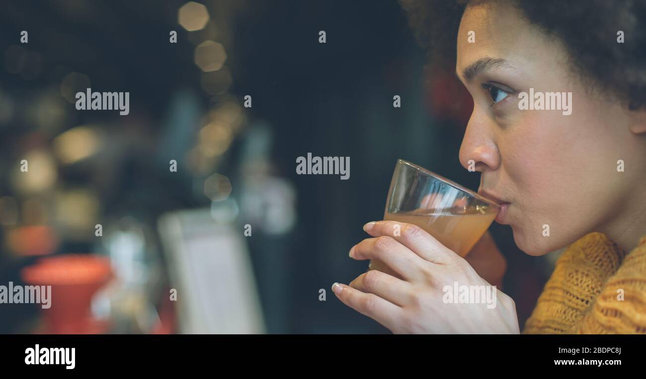 Portrait of beautiful young woman enjoying tea in a restaurant Stock ...