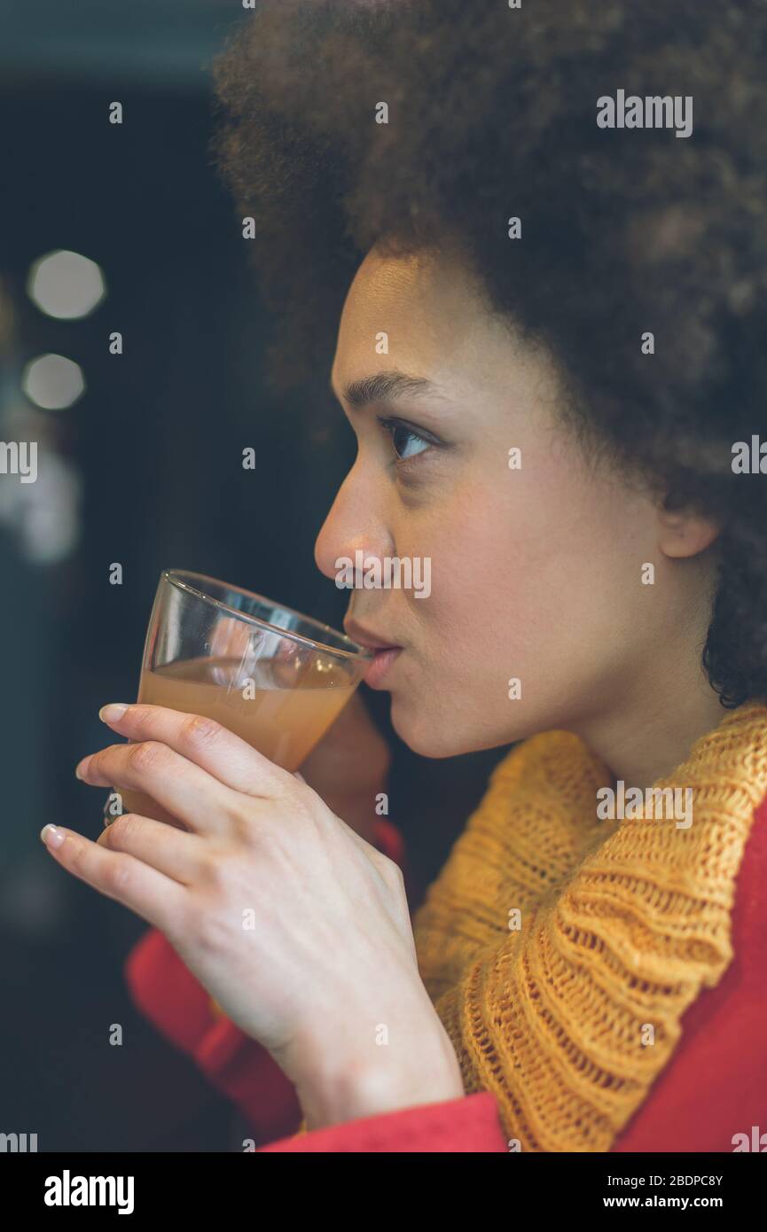 Portrait of beautiful young woman enjoying tea in a restaurant Stock ...