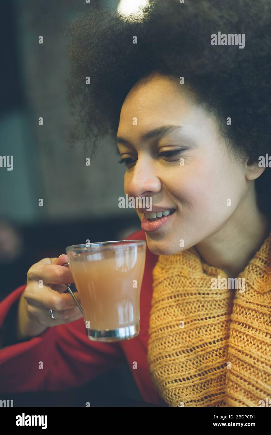 Portrait of beautiful young woman enjoying tea in a restaurant Stock ...