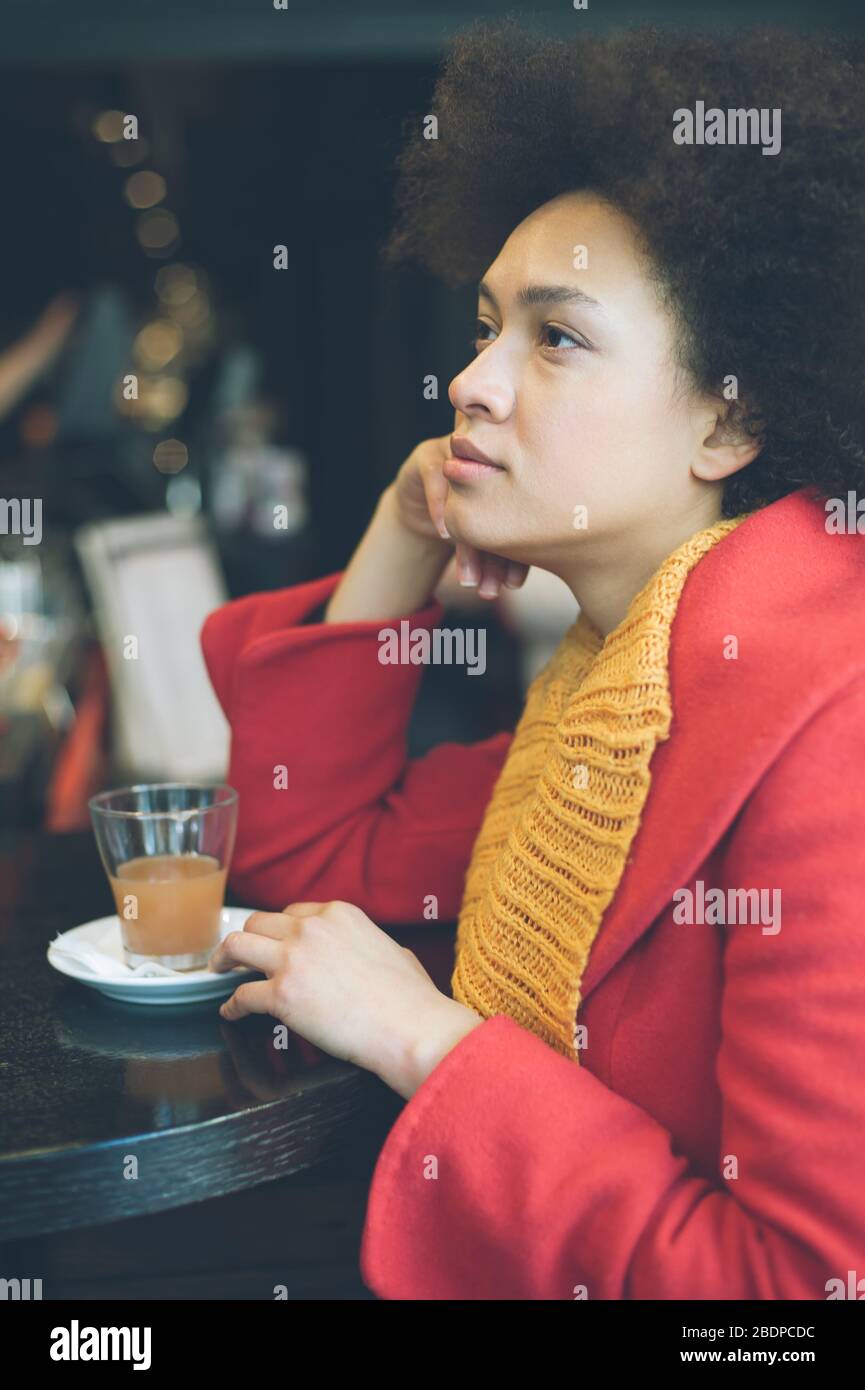 Portrait of beautiful young woman enjoying tea in a restaurant Stock ...