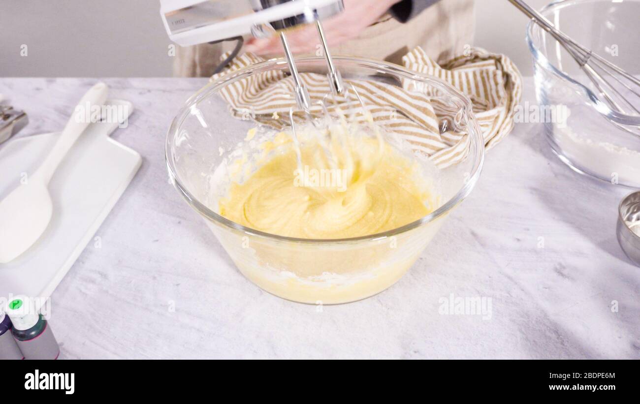 Step by step. Mixing ingredient in a mixing bowl with an electric mixer ...