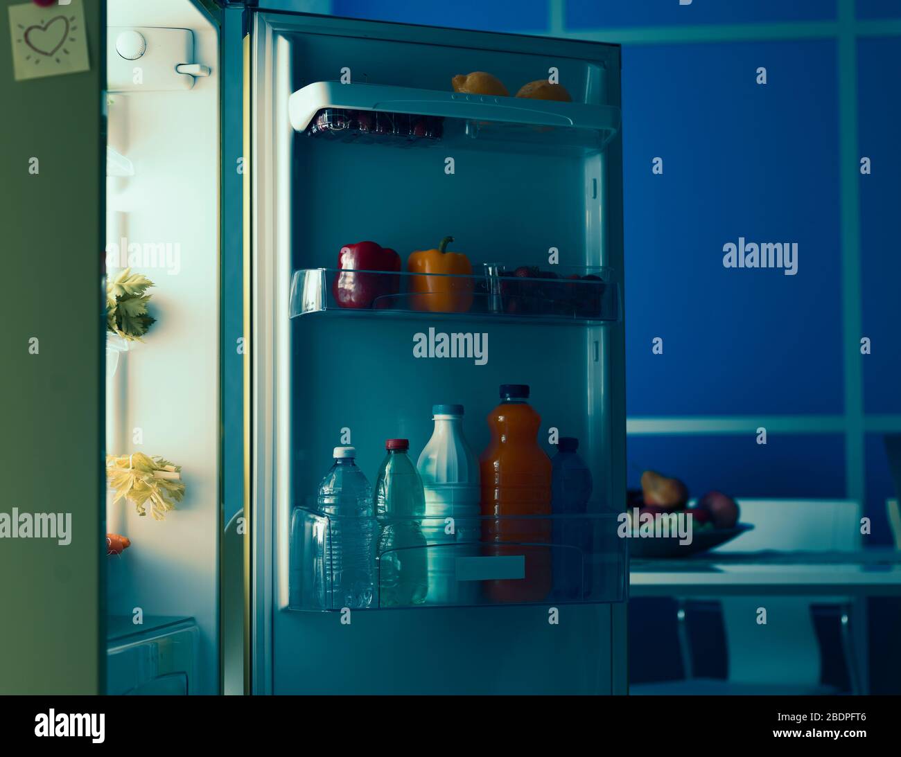 Open fridge in the kitchen with healthy fresh food and drinks Stock ...