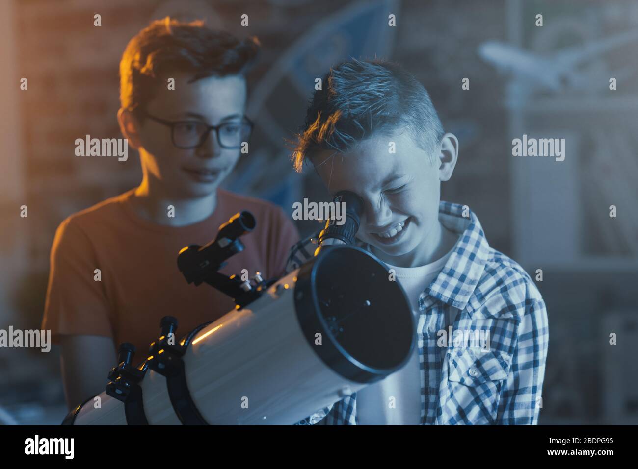 Smart kids using a telescope and studying astronomy together in their ...