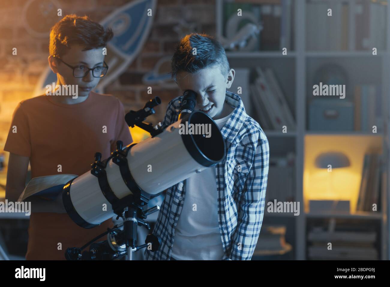 Smart kids using a telescope and studying astronomy together in their ...