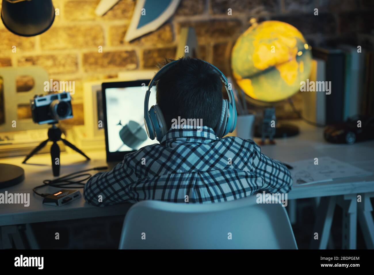 Smart nerd boy connecting with his laptop in the bedroom, kids and ...