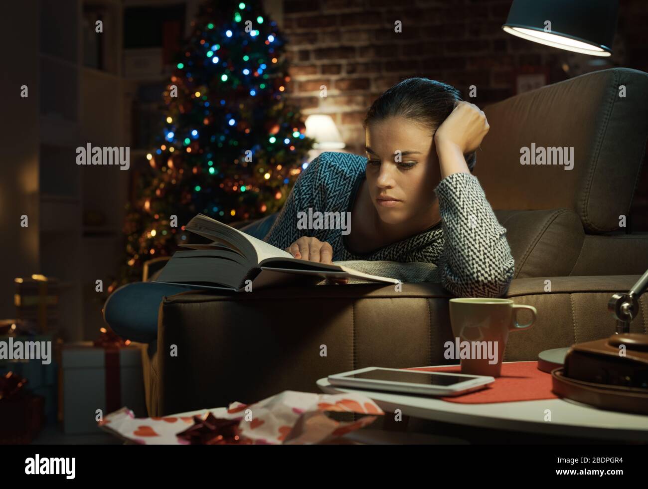 Woman reading book she received hi-res stock photography and images - Alamy