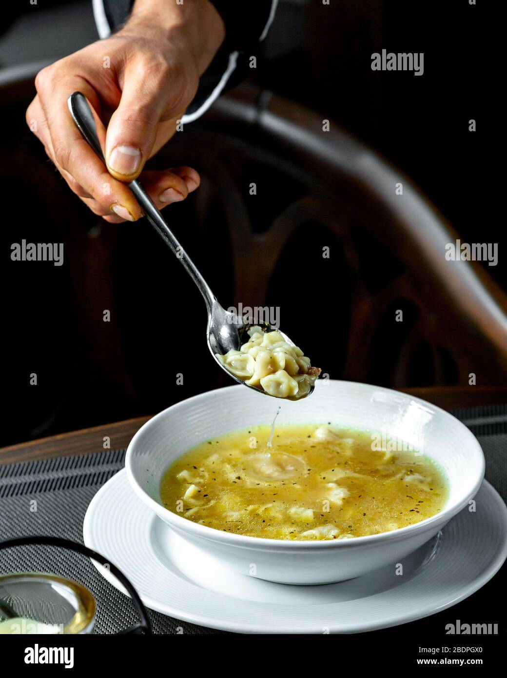 dushbara soup and fork filled with it Stock Photo - Alamy