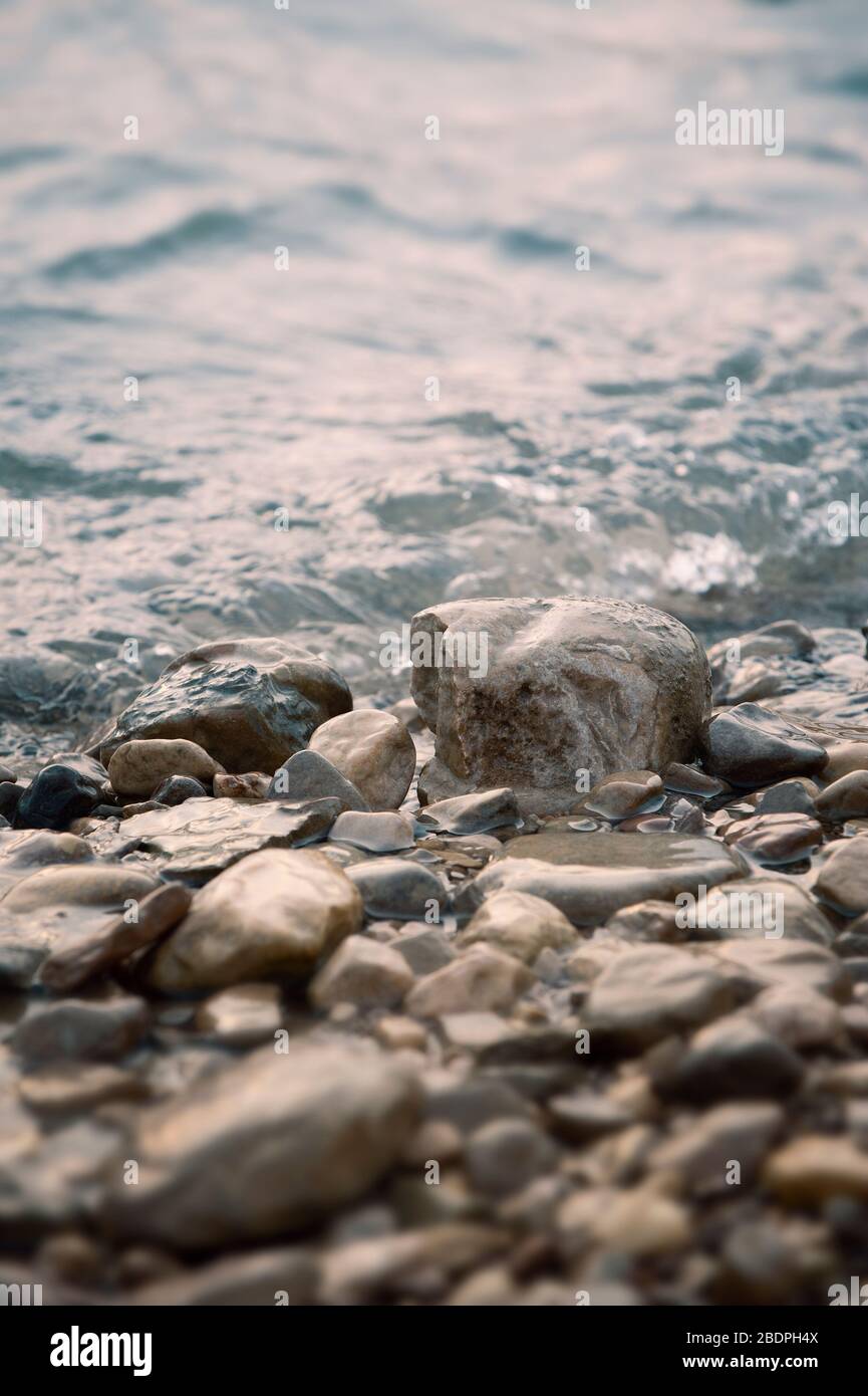 The shoreline of a lake, formed by pale pink rocky pebbles Stock Photo ...