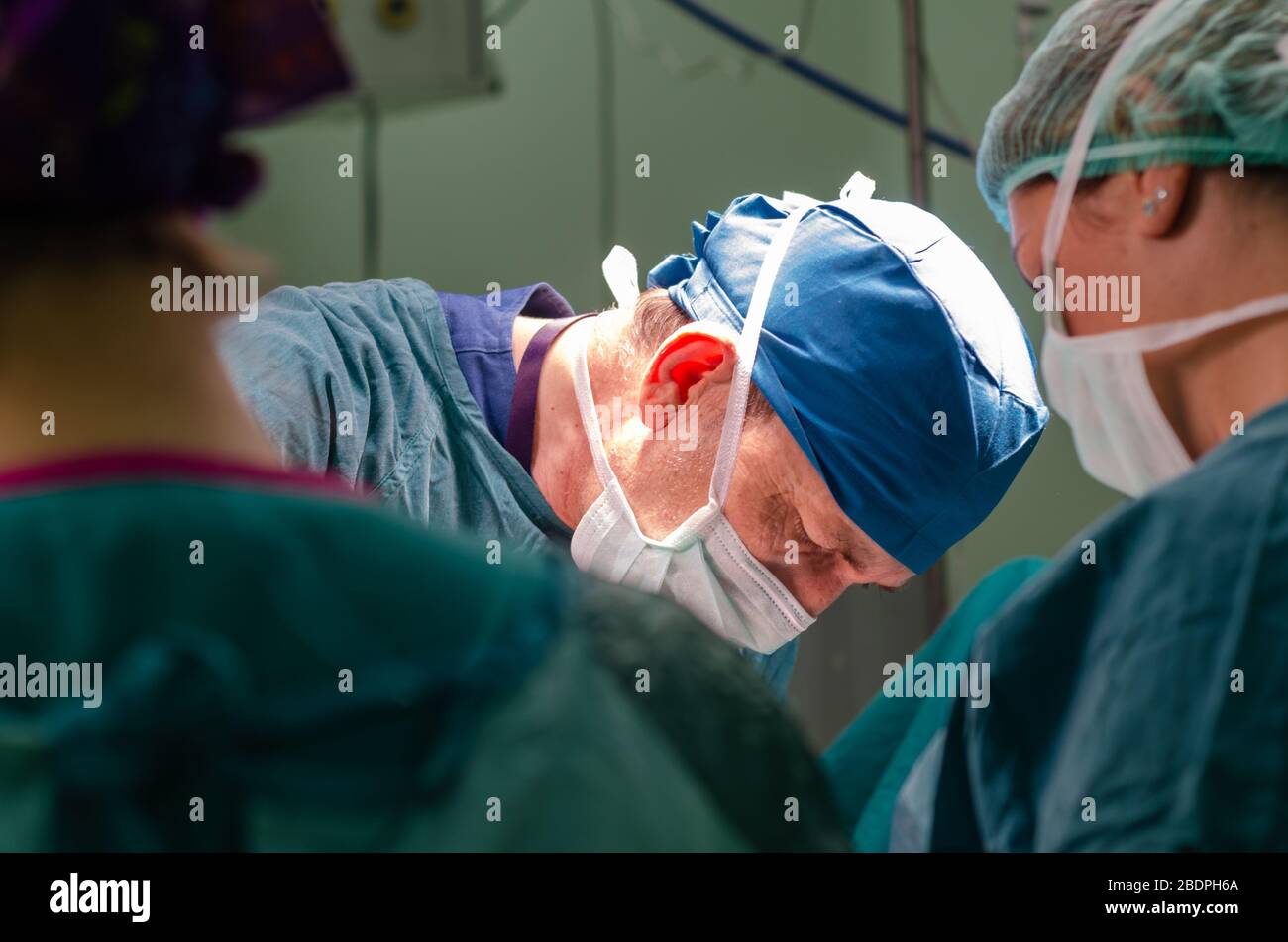 Concentrated doctor and assistant during a hysterectomy operation in a ...