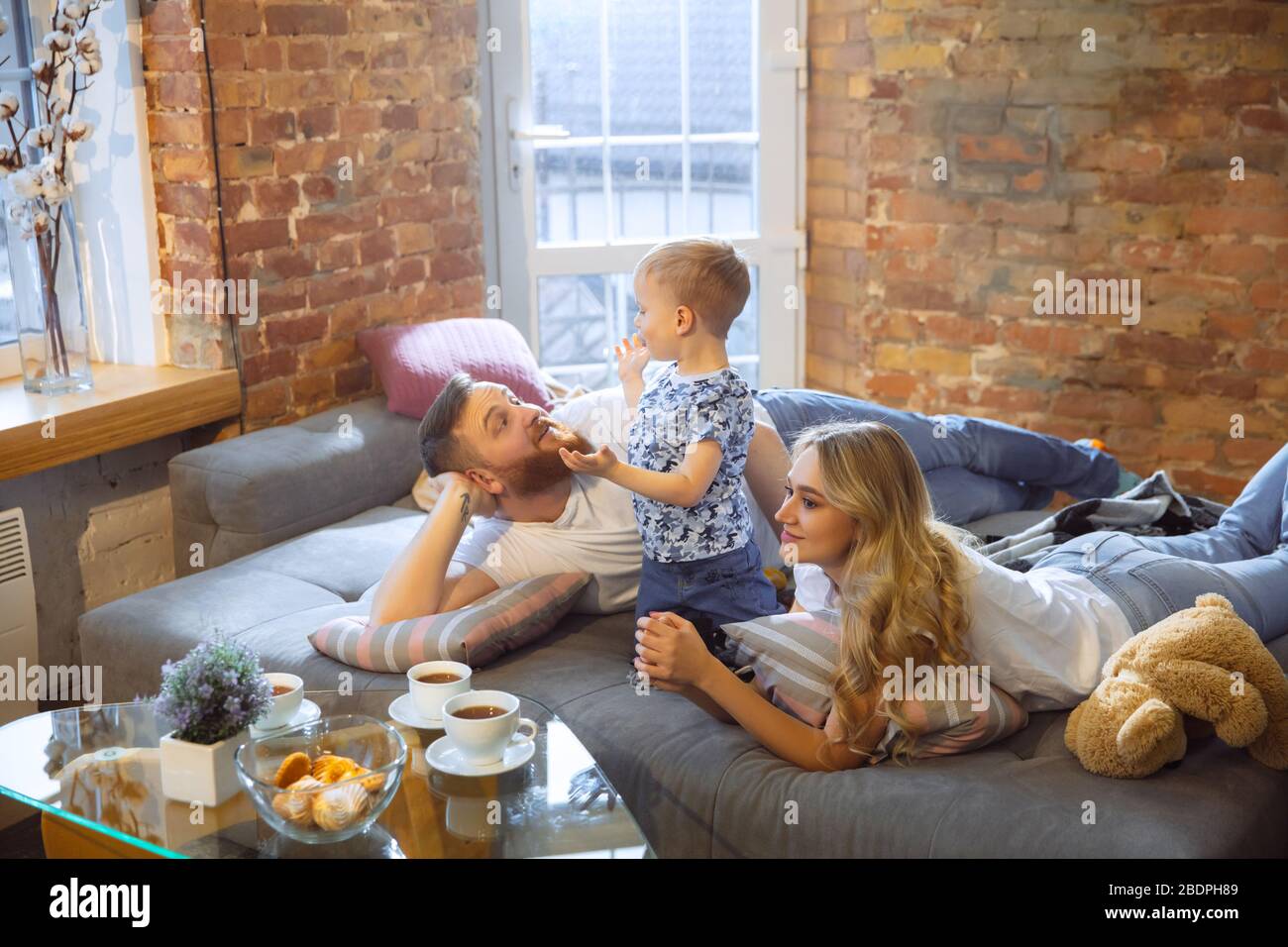 Mother, father and son at home having fun, comfort and cozy concept ...