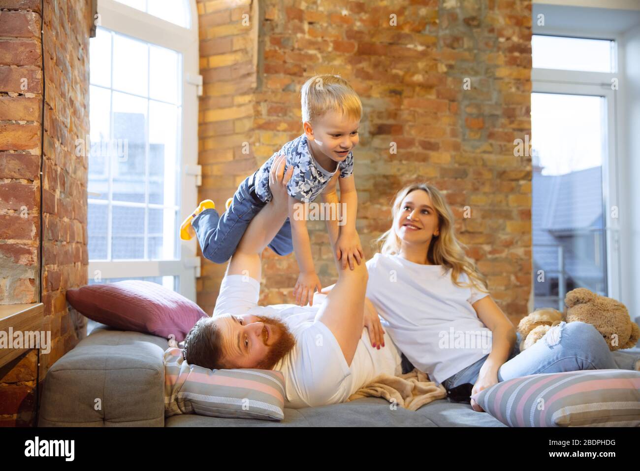 Mother, father and son at home having fun, comfort and cozy concept ...