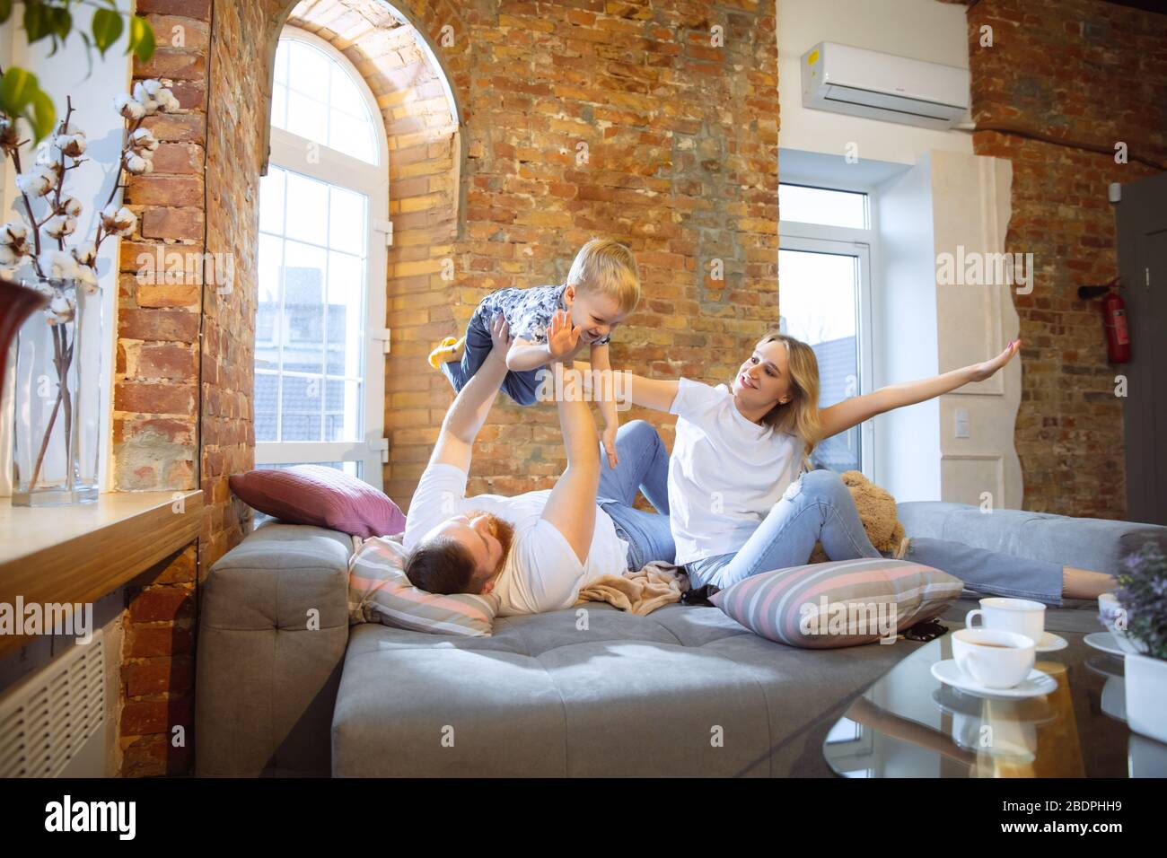 Mother, father and son at home having fun, comfort and cozy concept ...