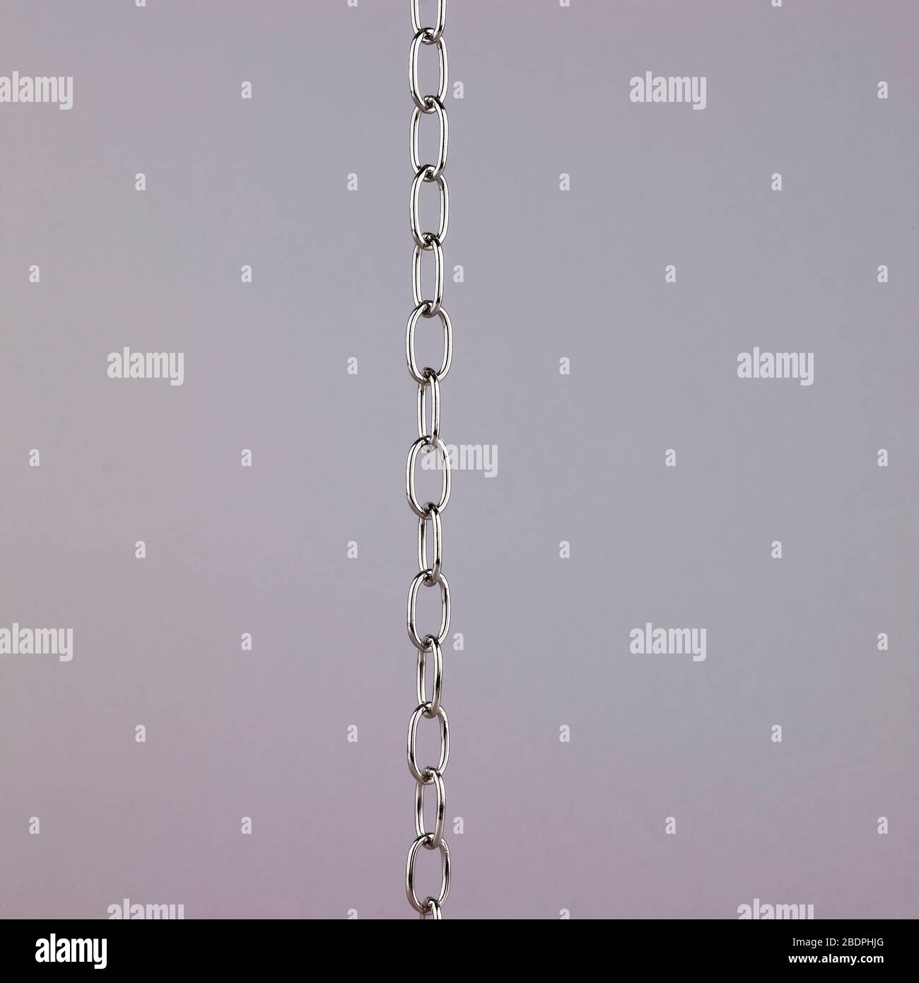 Stainless steel chain against grey background Stock Photo - Alamy