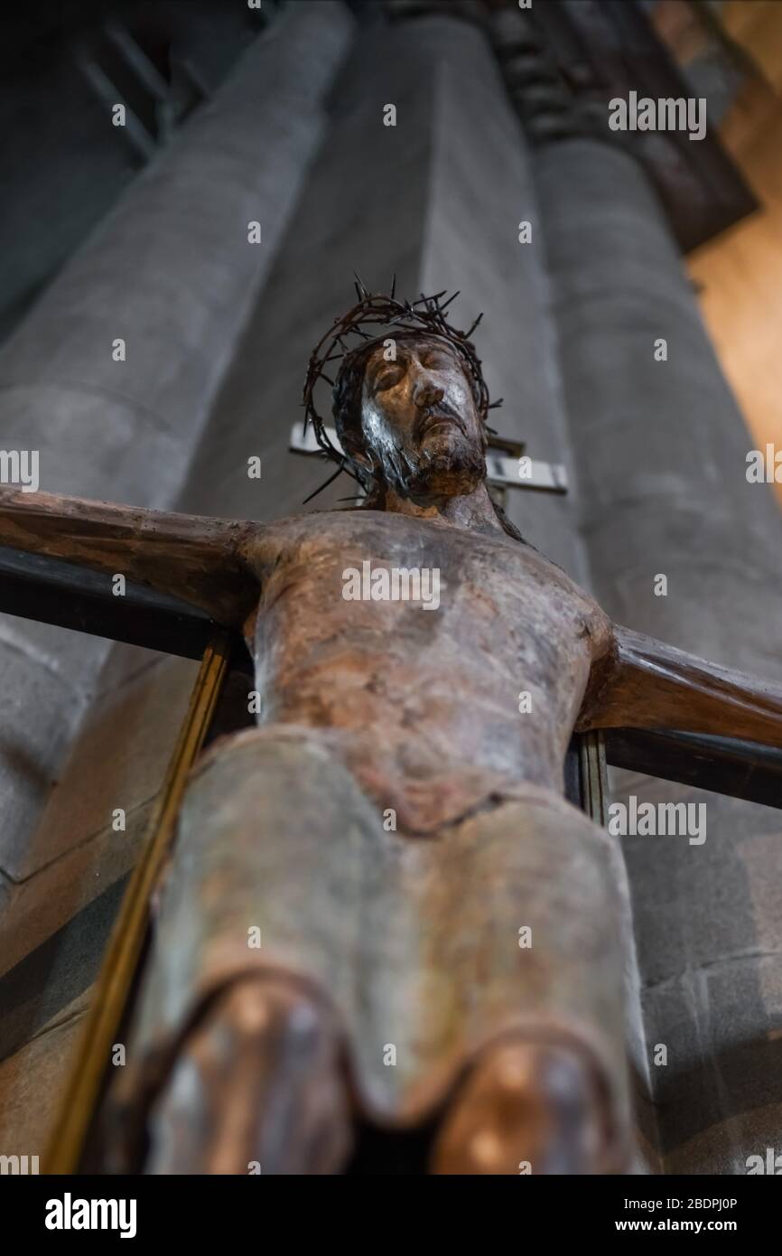 A statue of Jesus hanging from a cross Stock Photo - Alamy