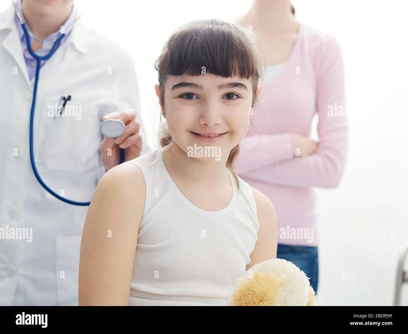 Happy smiling girl in the doctor's office during a visit, healthcare ...