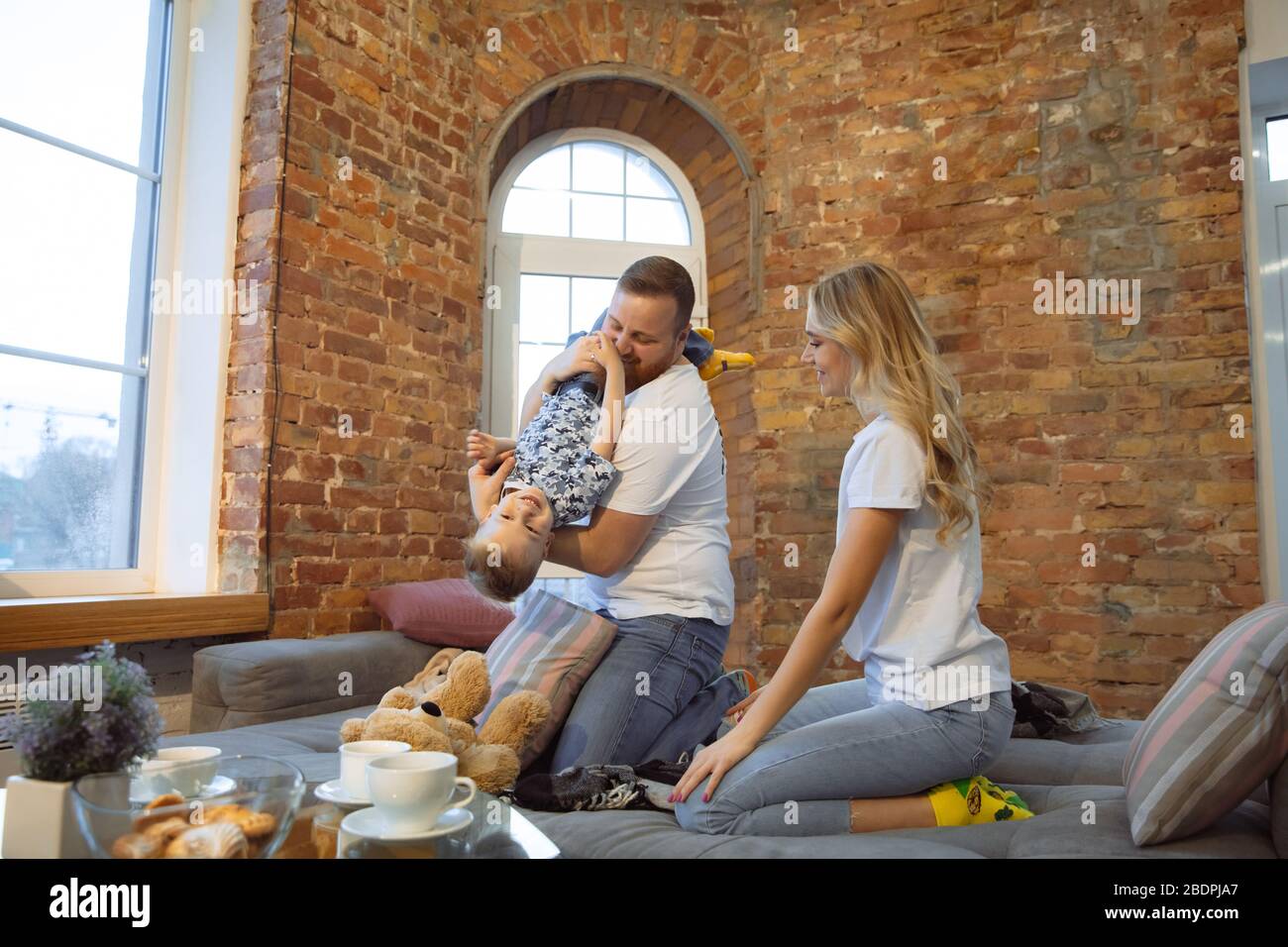 Mother, father and son at home having fun, comfort and cozy concept ...