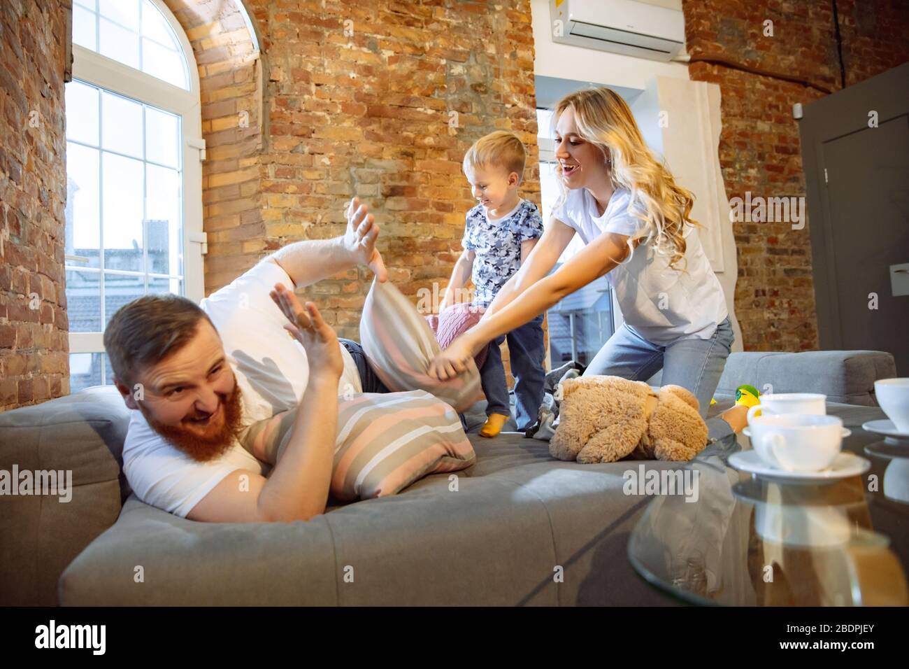 Mother, father and son at home having fun, comfort and cozy, love ...