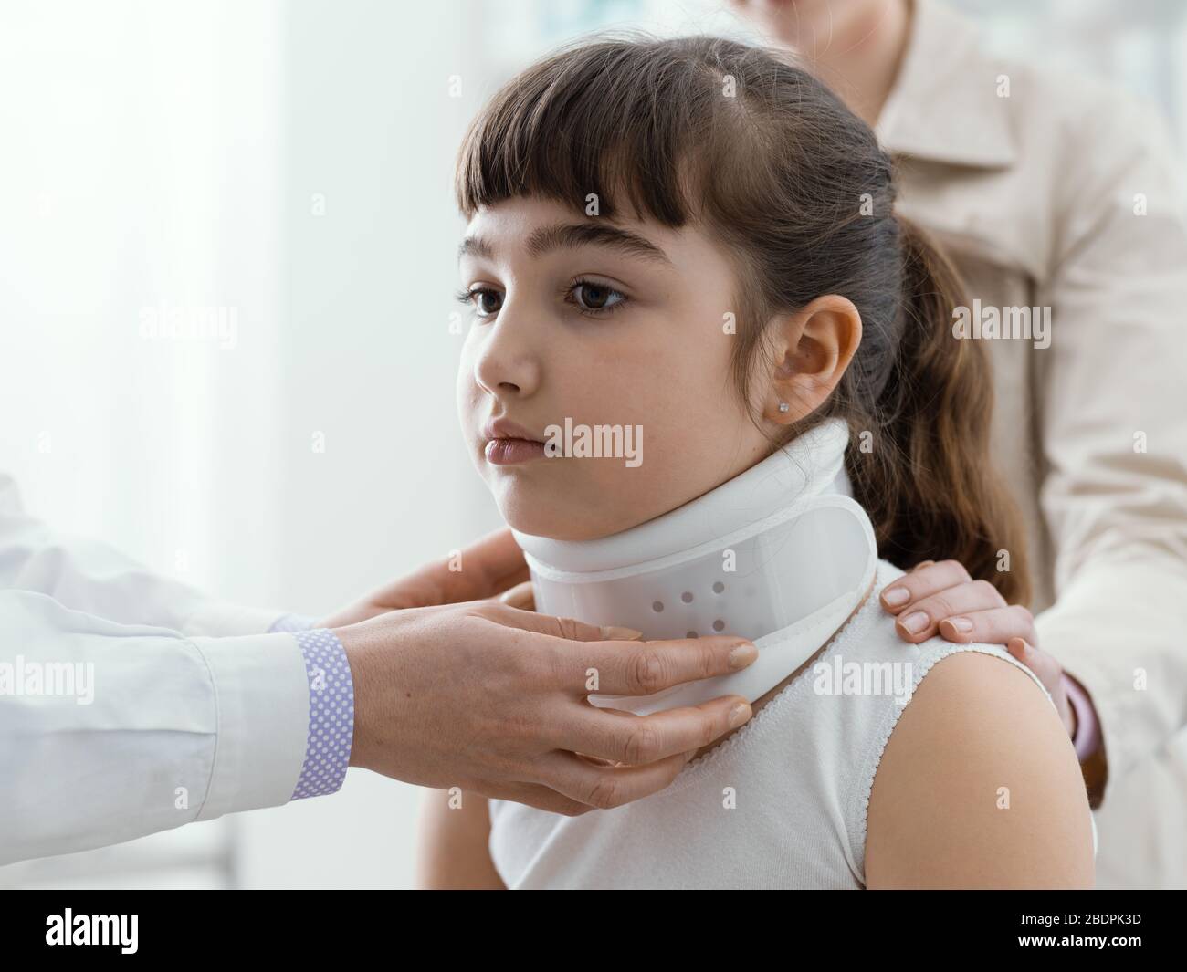 Doctor visiting a young girl with orthopedic cervical collar, first aid ...