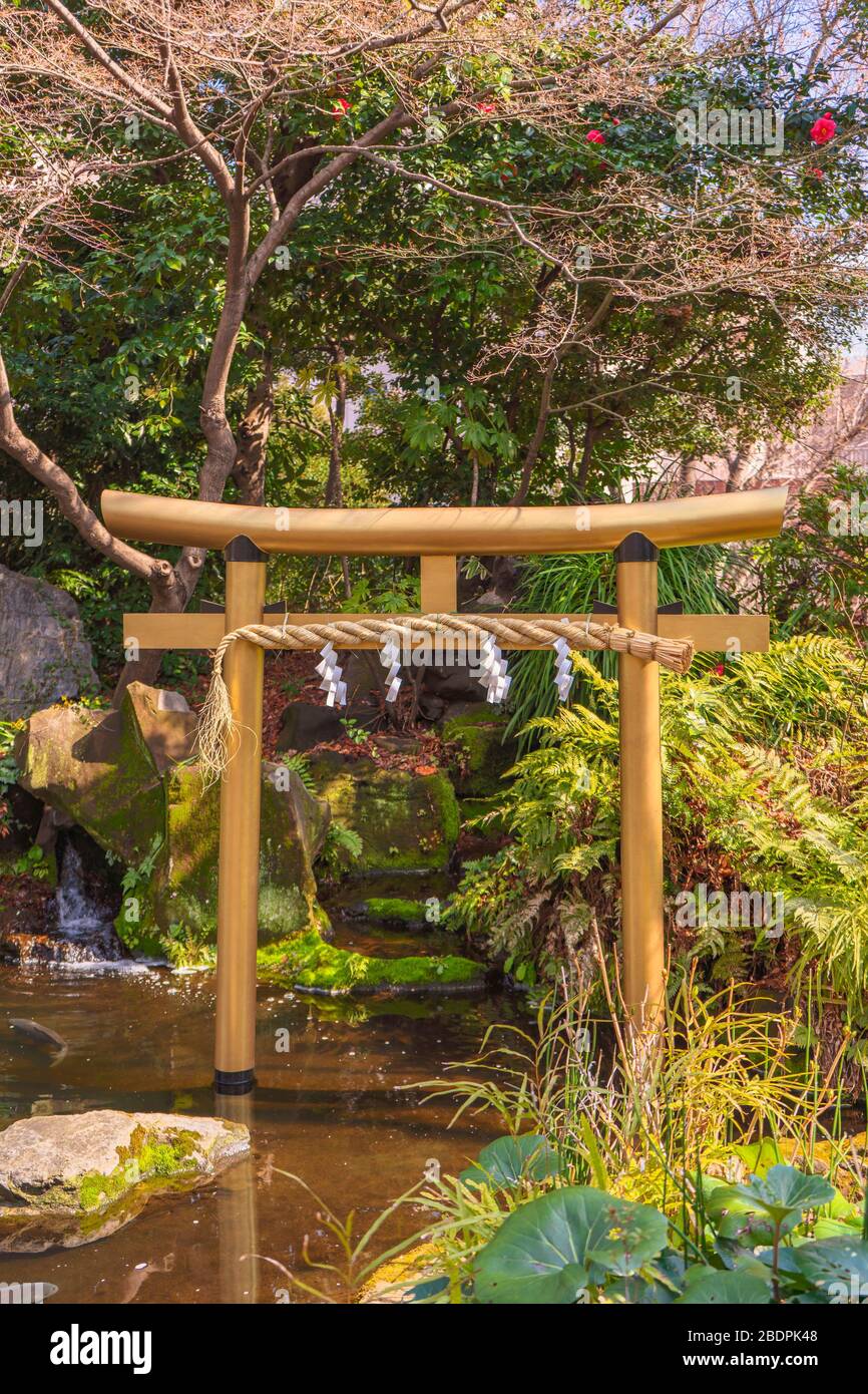 tokyo, japan - march 05 2020: Golden torii gate decorated with a ...