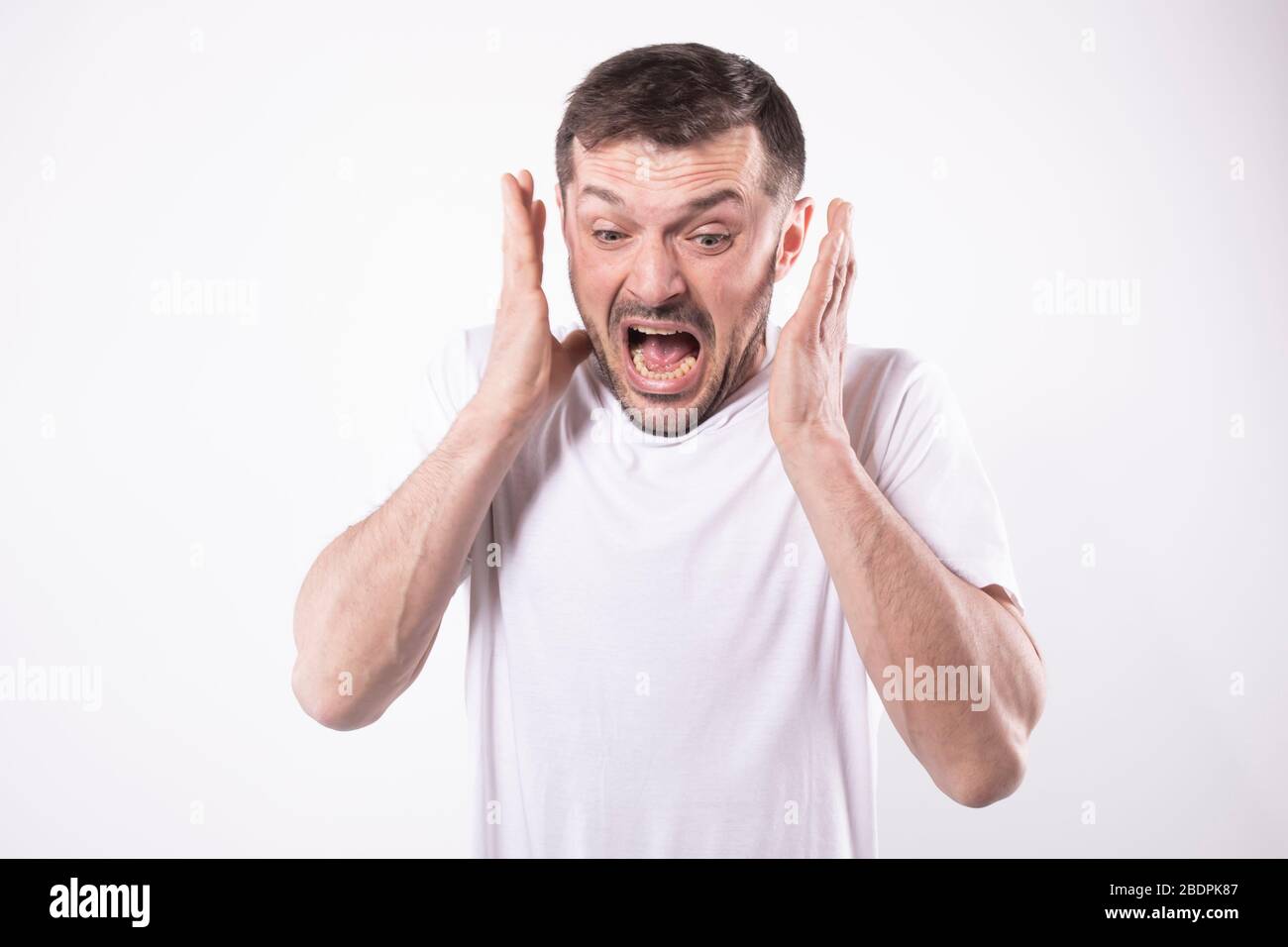 Scared man, hands in a panic pose. Isolated on white background. Human ...