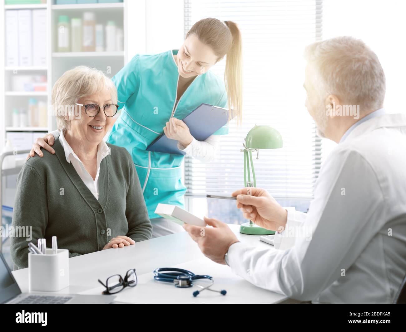 Professional doctor sitting at office desk and giving a prescription ...