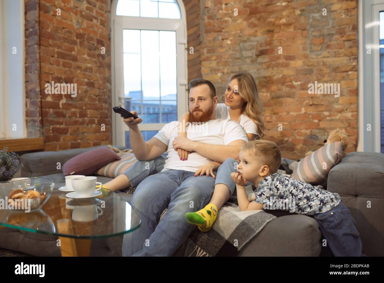 Mother, father and son at home having fun, comfort and cozy, love ...