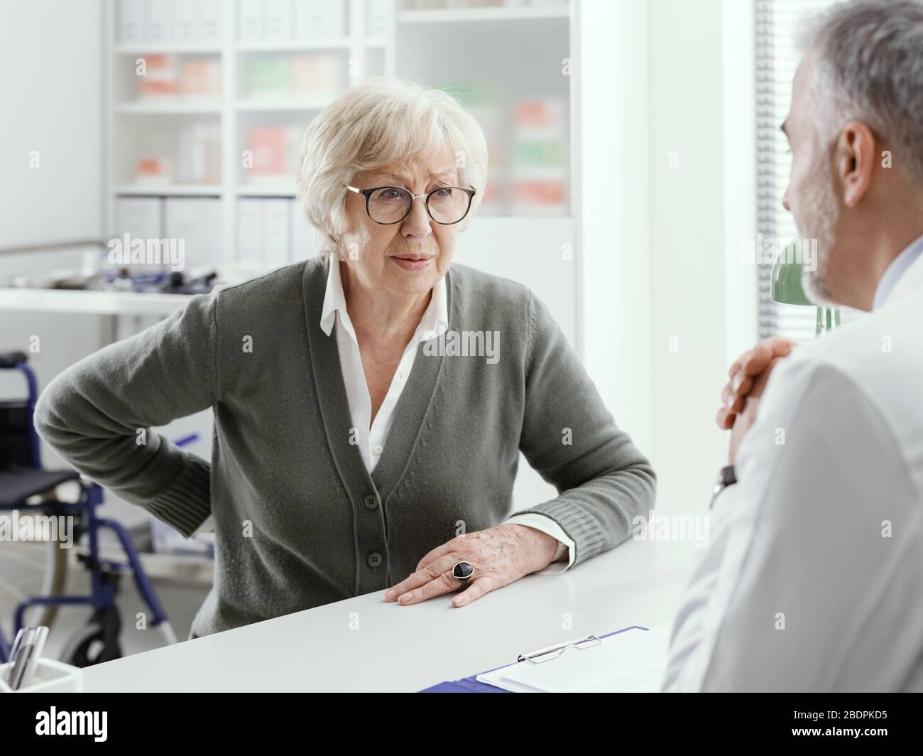 Senior lady in the doctor's office, she has back pain and rheumatism ...