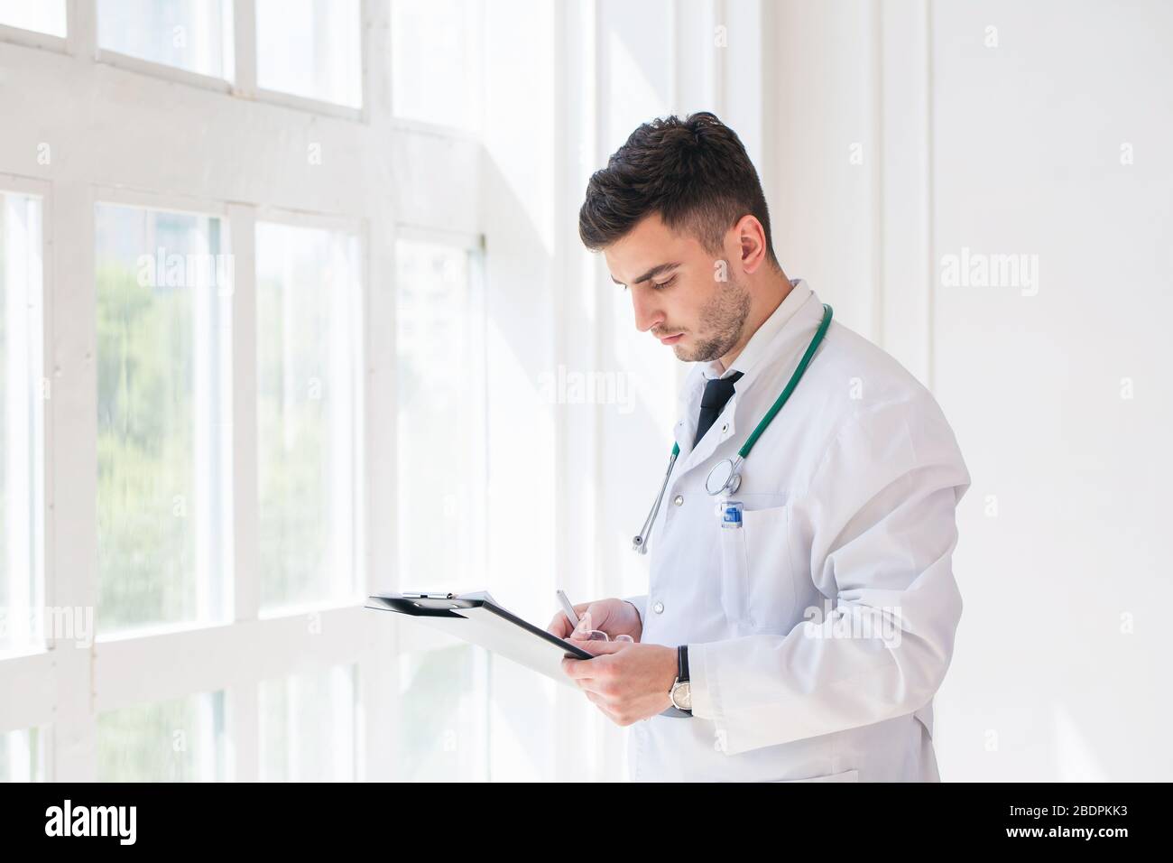 Doctor working near window in a hospital Stock Photo - Alamy
