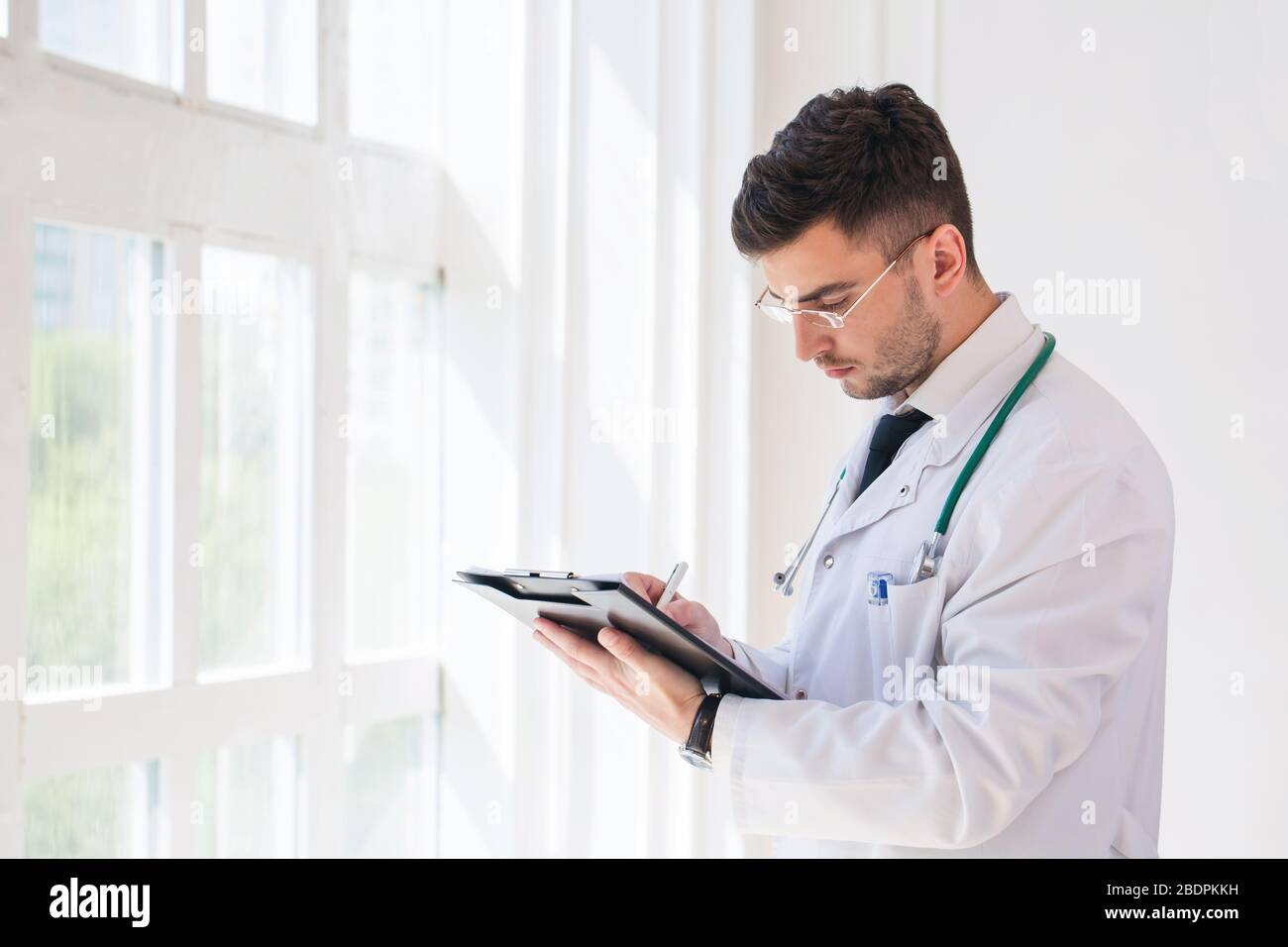 Doctor working near window in a hospital Stock Photo - Alamy