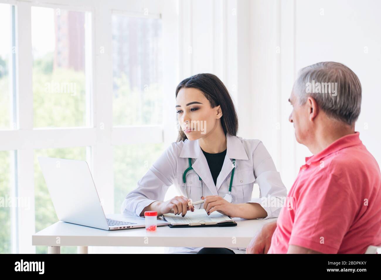 Senior patient listen to young woman doctor in a hospital Stock Photo ...
