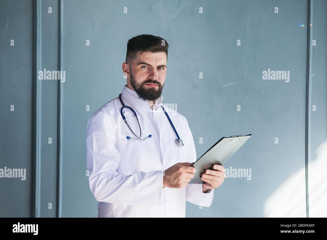 Doctor working near window in a hospital Stock Photo - Alamy