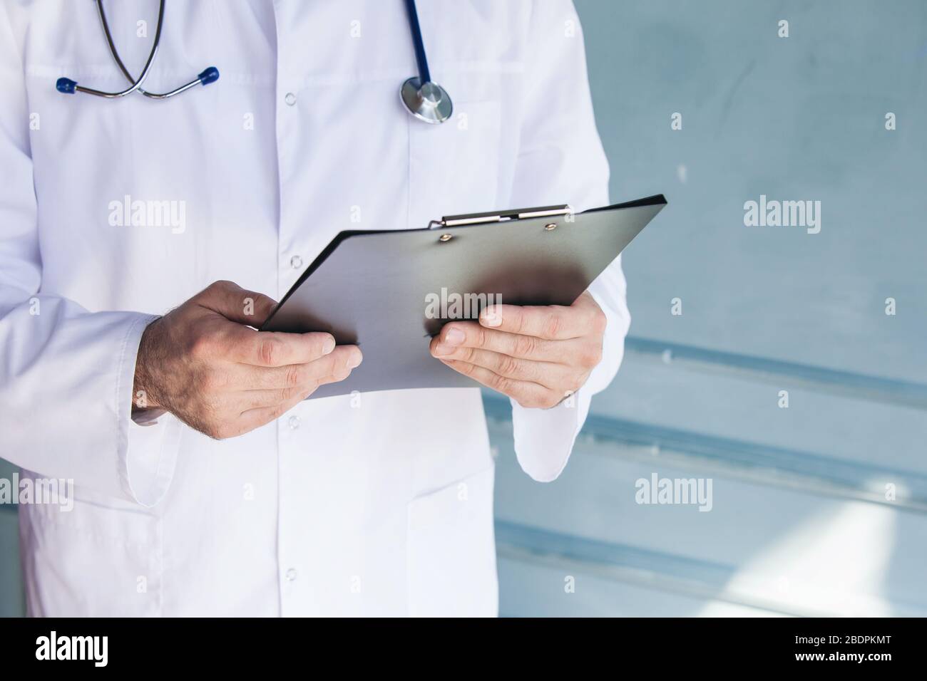 Doctor working near window in a hospital Stock Photo - Alamy