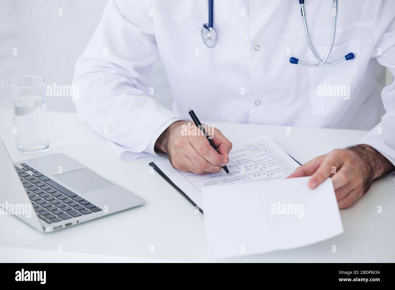 Doctor checking documents hi-res stock photography and images - Alamy