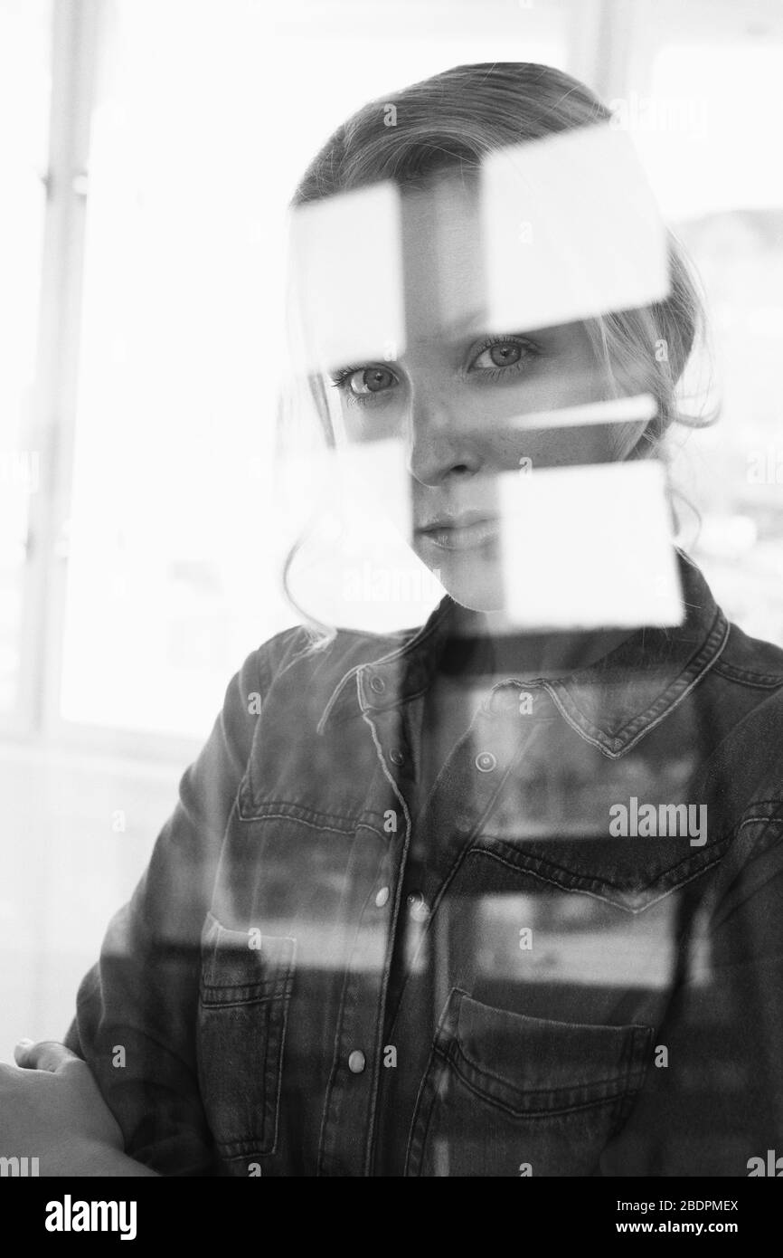 Beautiful blond woman through the window. Art portrait in a photo ...