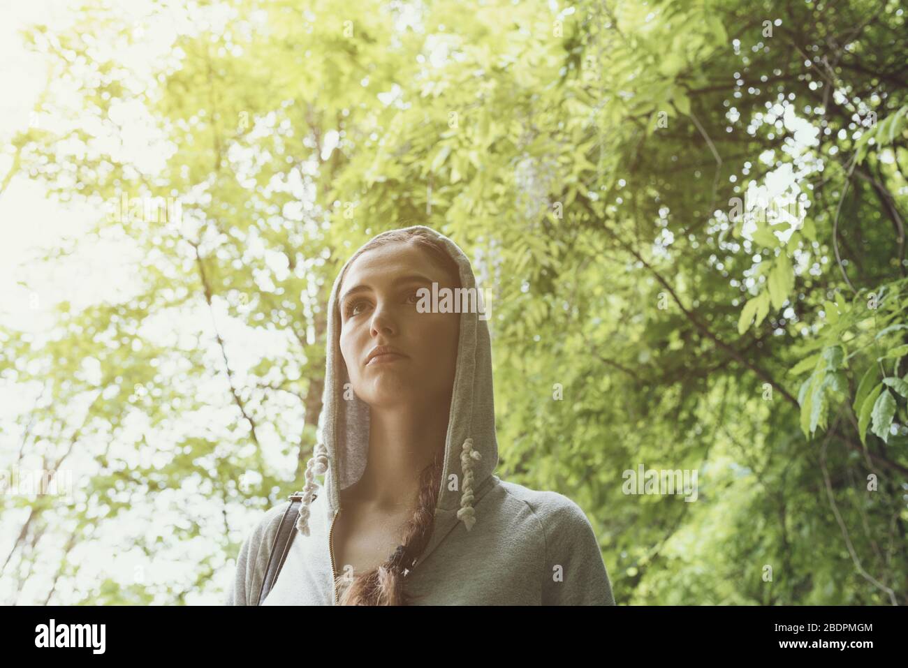 Sad hipster woman in trees hi-res stock photography and images - Alamy