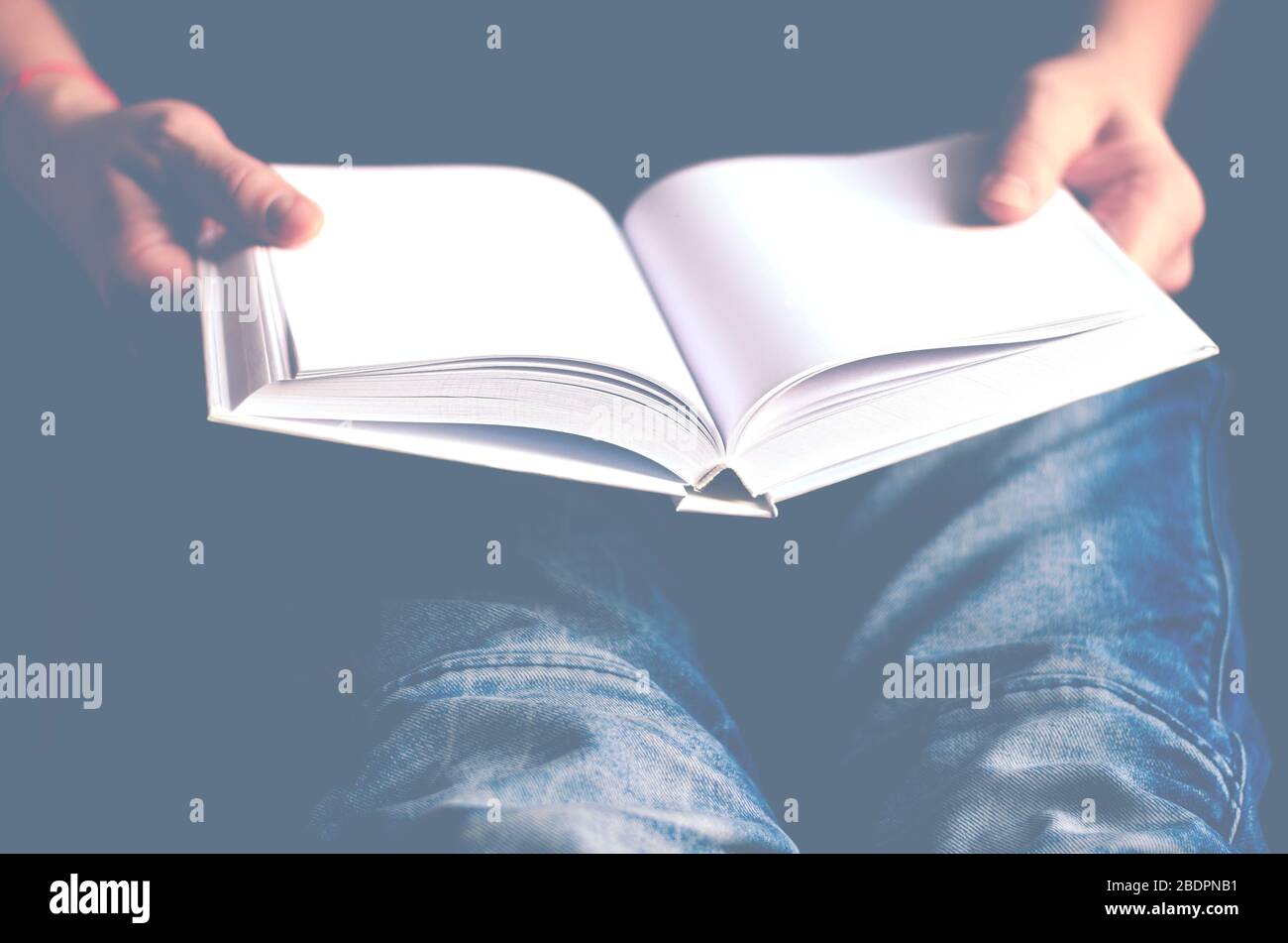 Men's hands hold a white book with clean pages Stock Photo - Alamy
