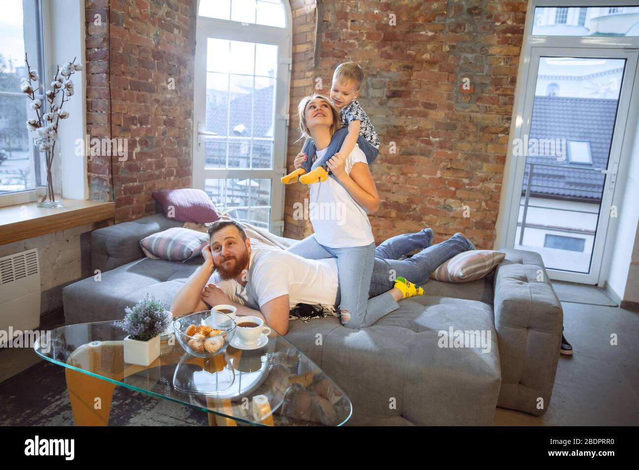 Emotions. Mother, father and son at home having fun, comfort and cozy ...